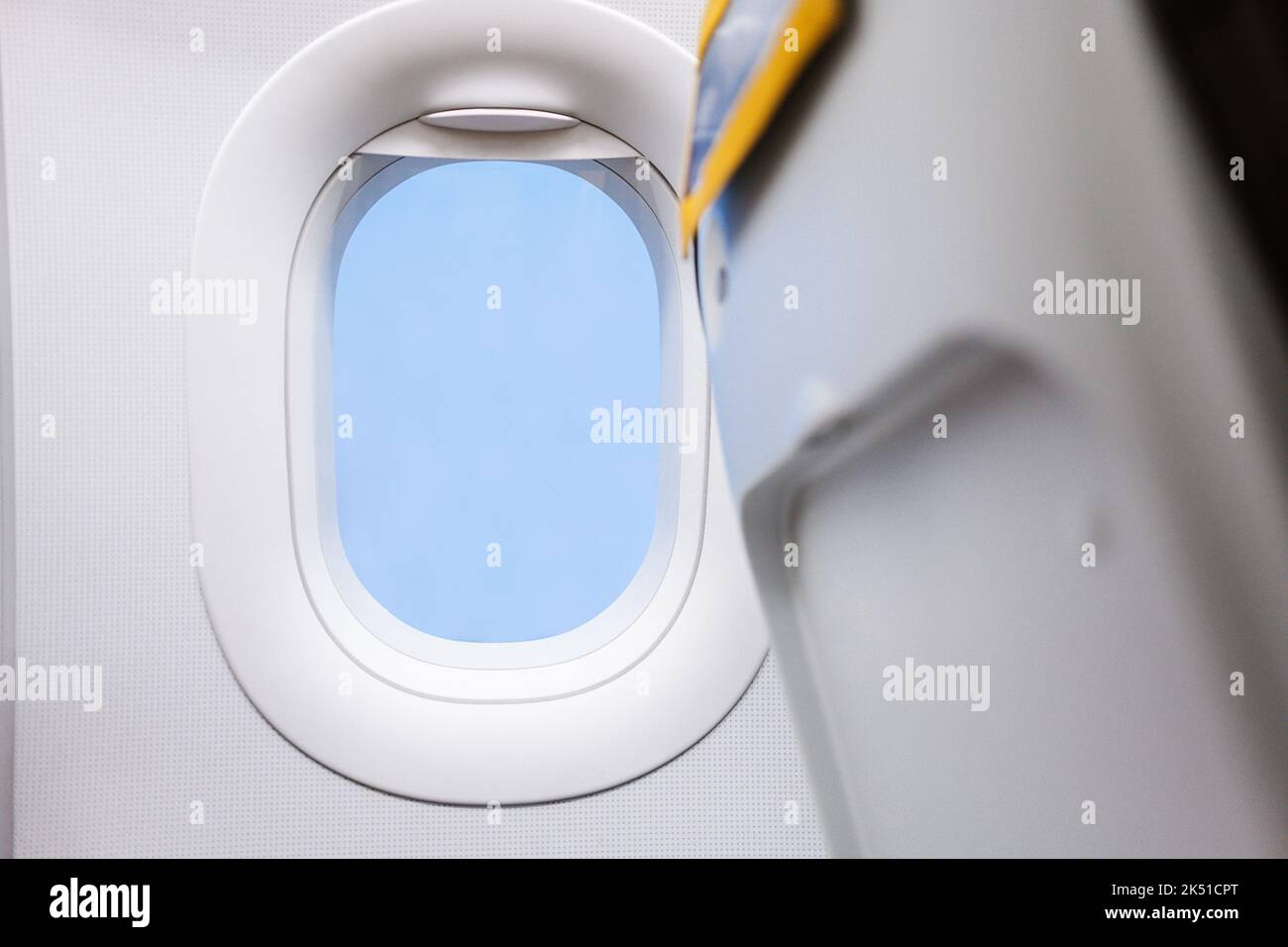 White windows of contemporary aircraft illuminating cabin interior with ...