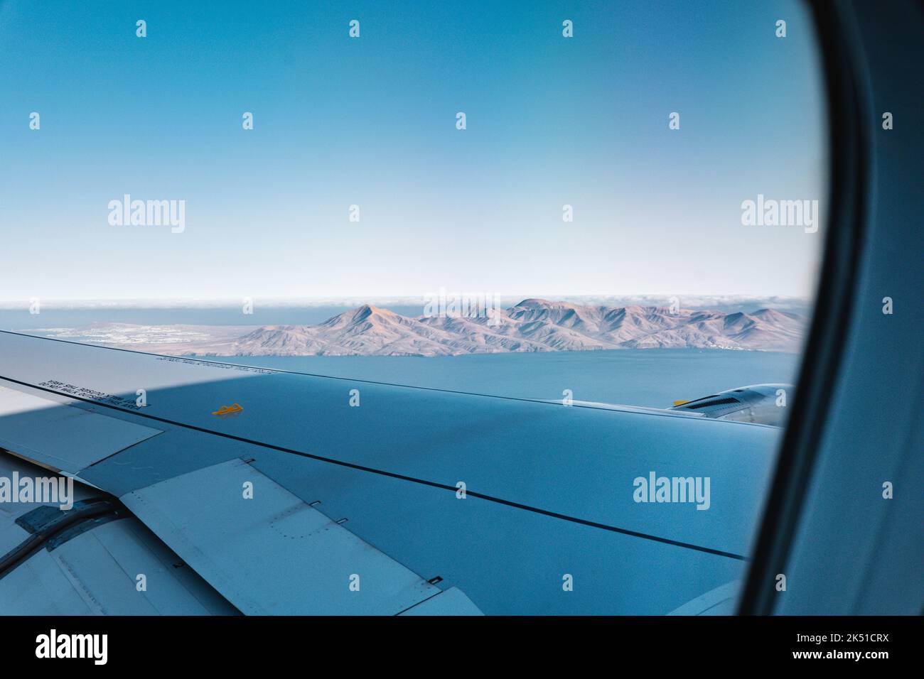 Spectacular view of wing of airplane flying over highland area during ...