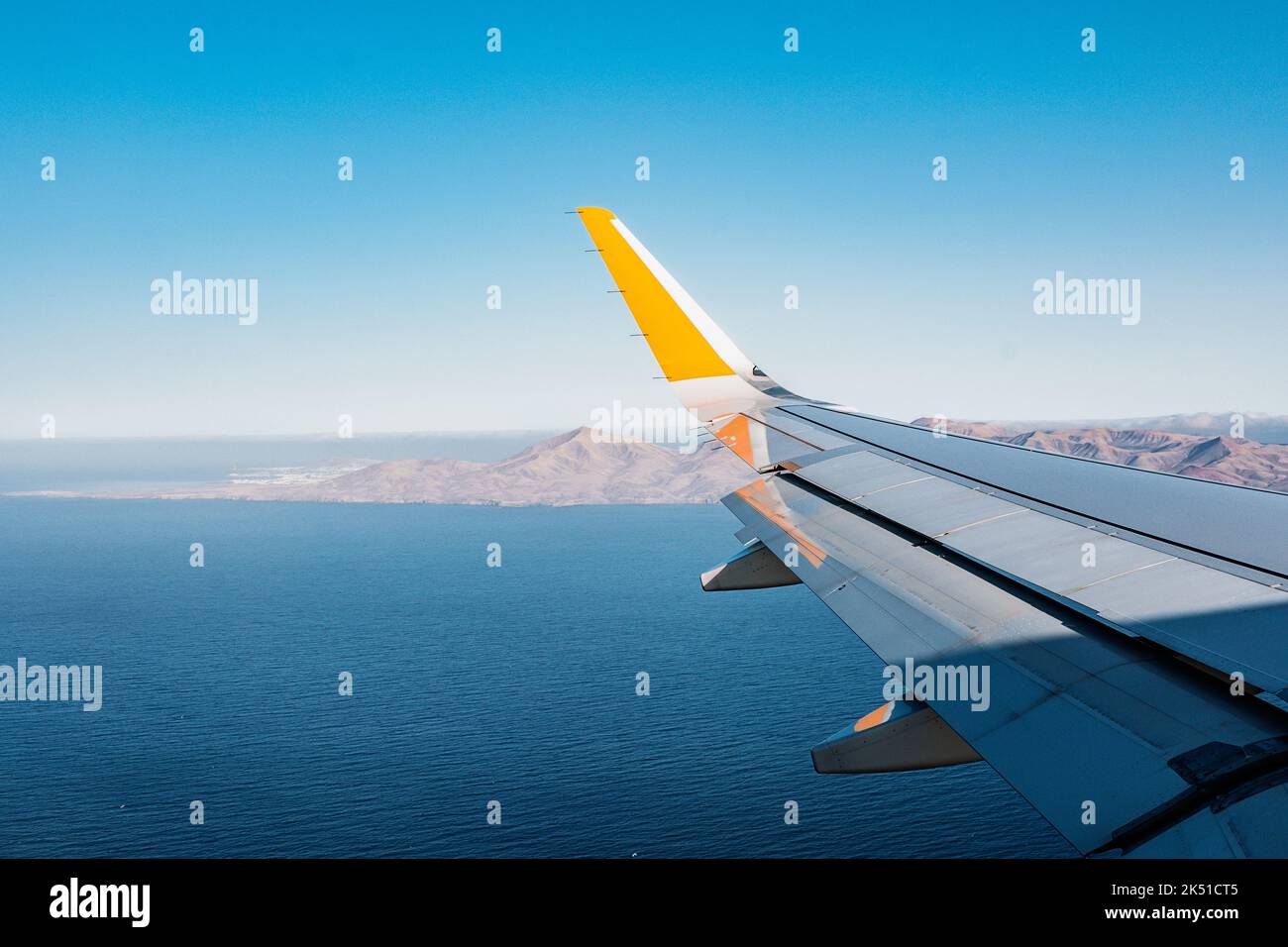 Spectacular view of wing of airplane flying over highland area during ...