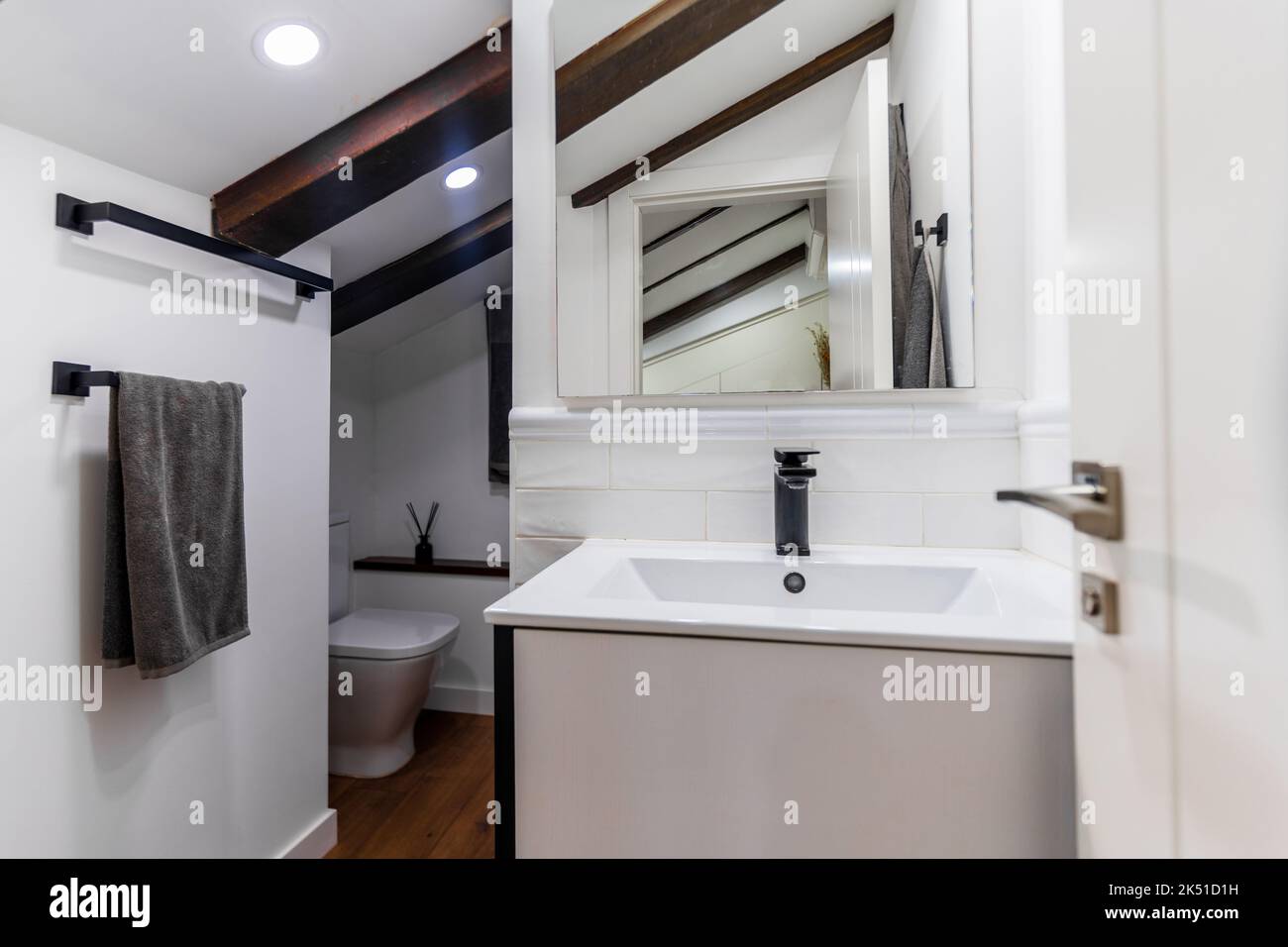Interior of small bathroom with ceramic toilet and sink near white ...