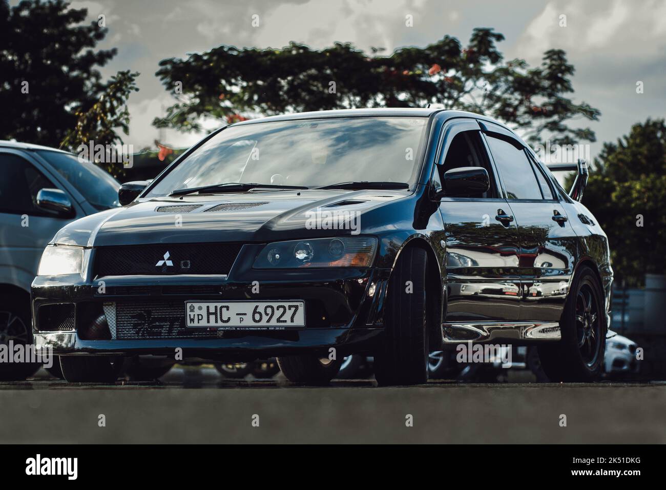 The view of a dark blue Mitsubishi Evo 7 car in a parking lot Stock Photo - Alamy