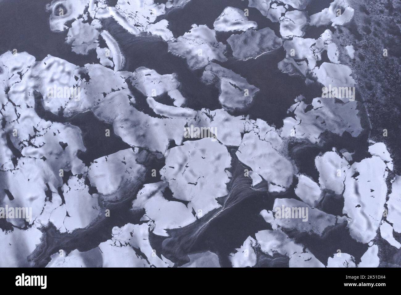 High angle of glaciers of various shapes on rough frozen lake water ...