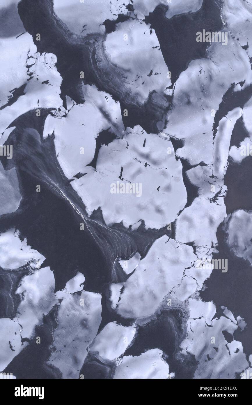 High angle of glaciers of various shapes on rough frozen lake water ...