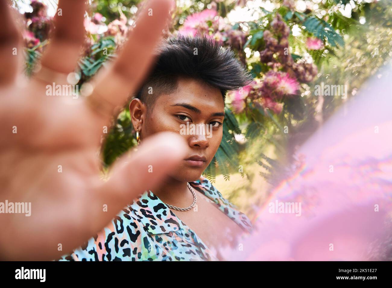 Asian non binary person without makeup looking at camera and making ...