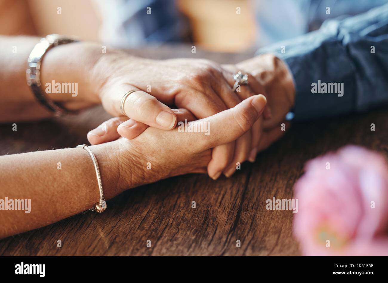 Macro, couple and elderly people holding hands on table for support ...