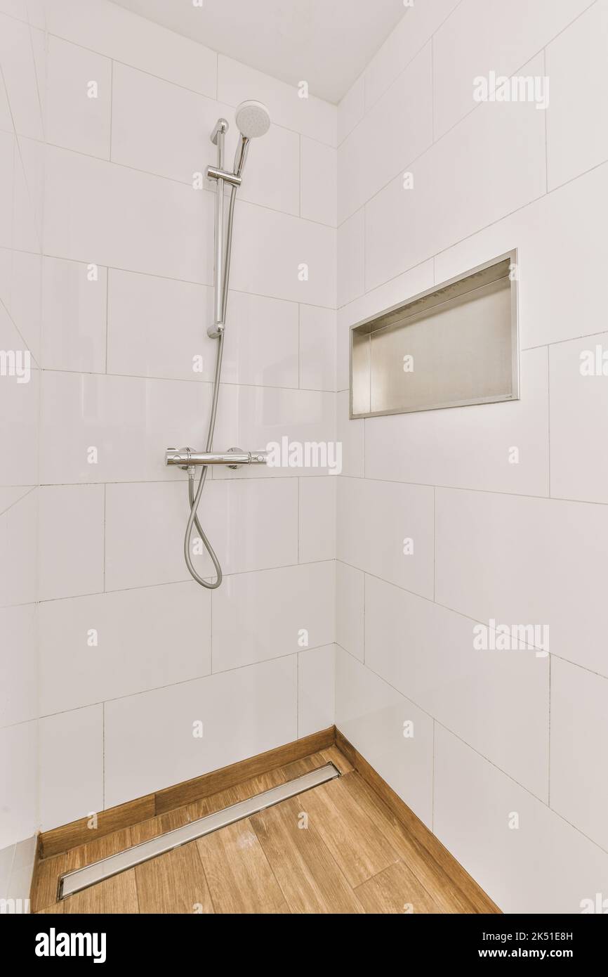 Interior of modern shower cabin with tiled walls and built in shelf and ...