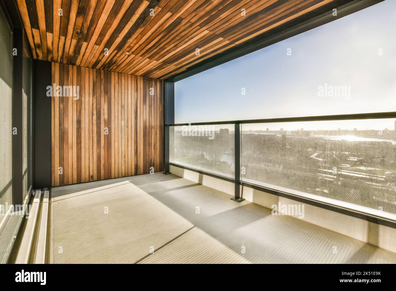 Part of balcony with metal railing and wooden walls in residential ...