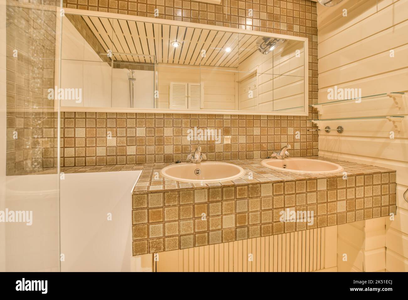 Sinks with taps installed under mirror in light bathroom of modern ...