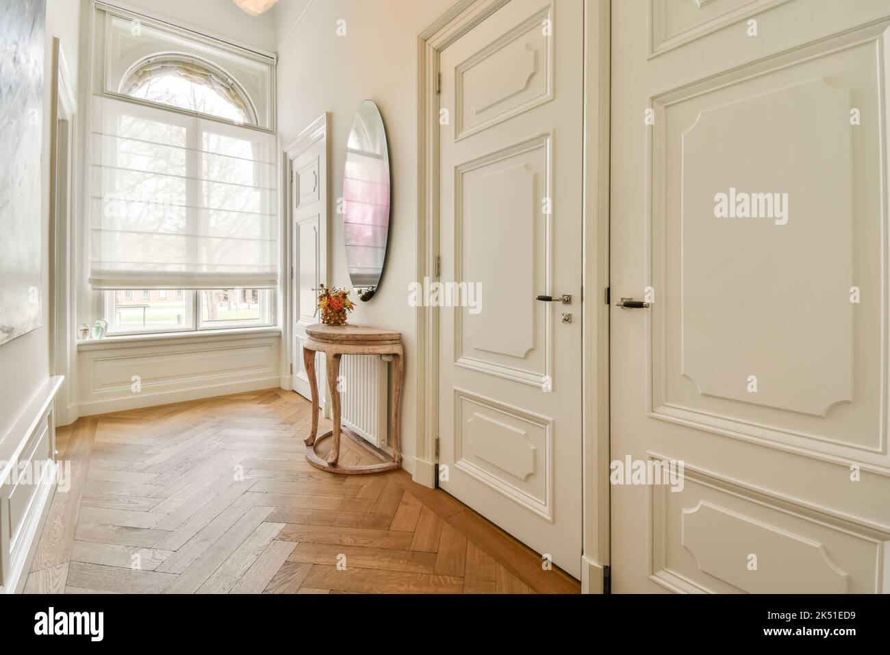 Interior passage way with mirror on wall in modern house Stock Photo - Alamy