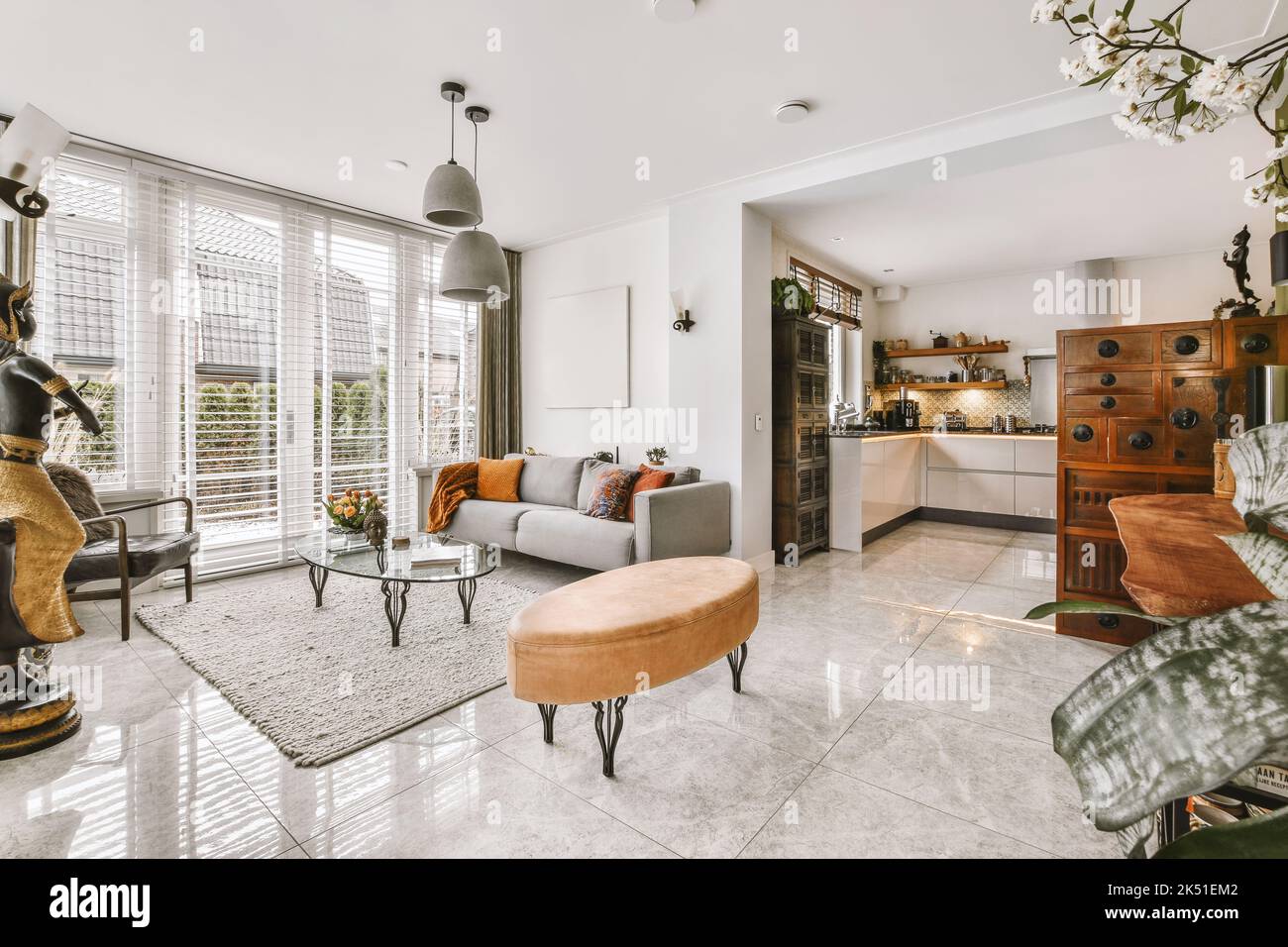 Interior of spacious living room with asian decor and sofa opposite ...