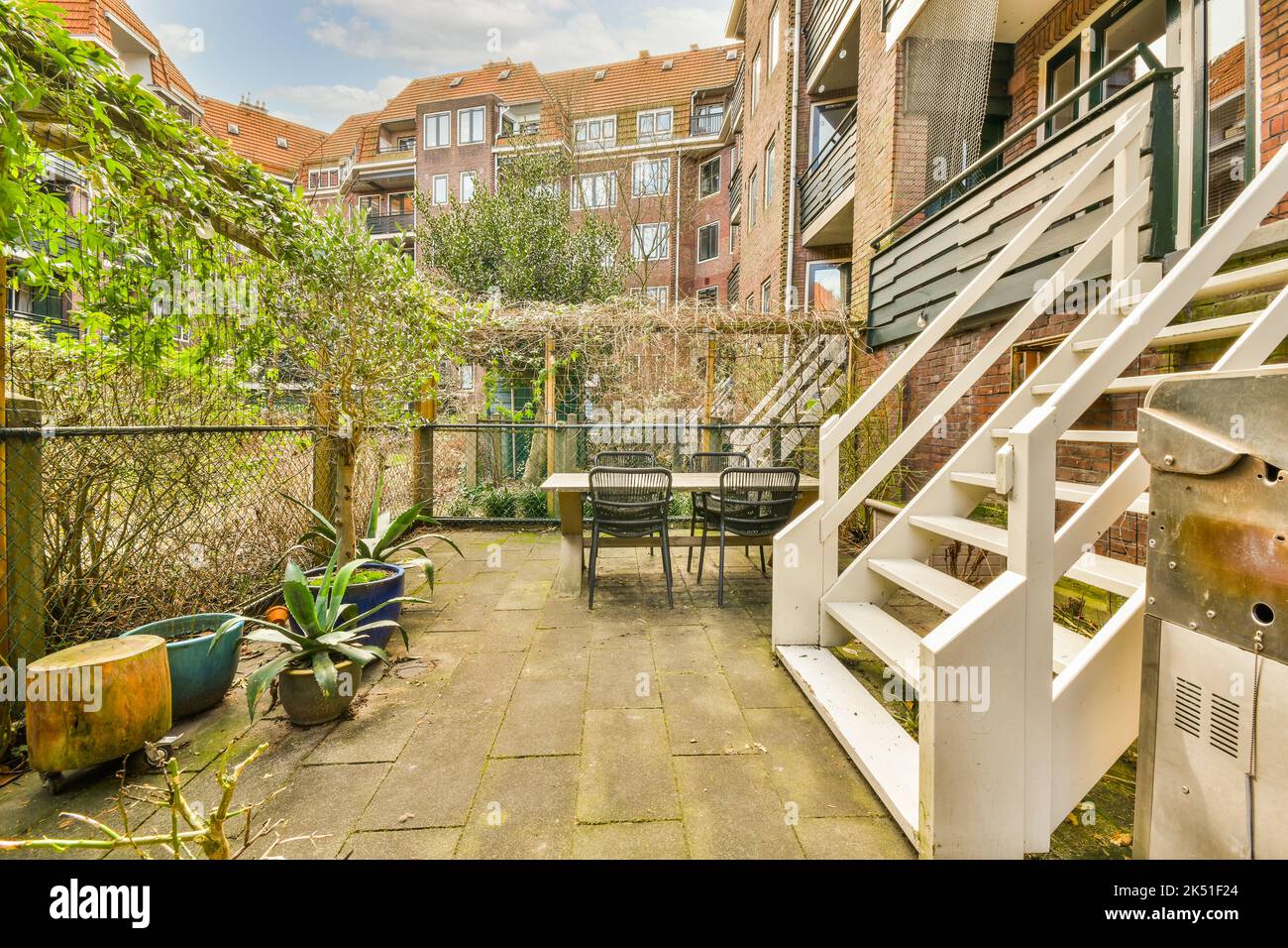 Terrace with metal fence and stairs of residential building located in ...