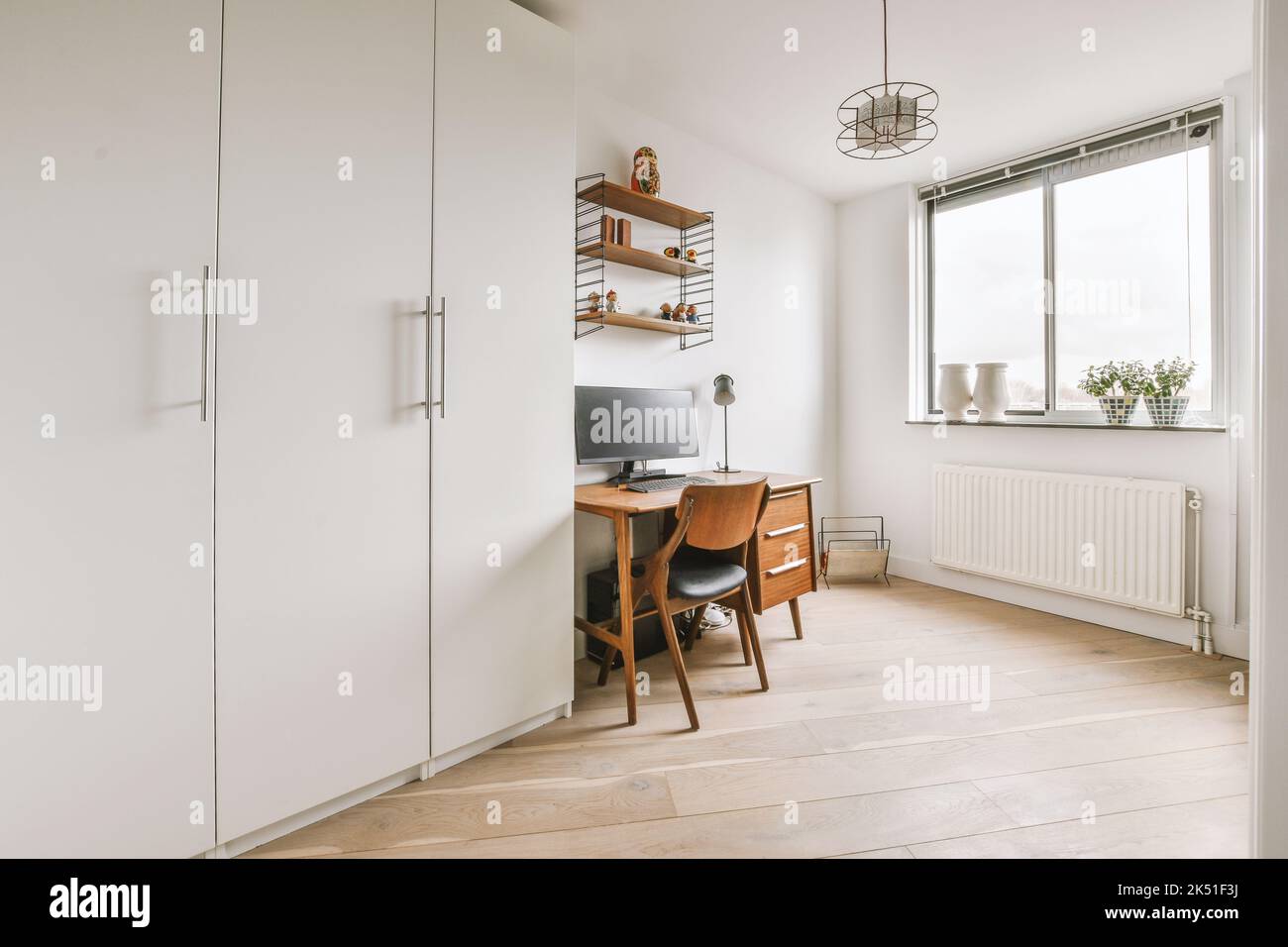 Interior of spacious room with built in closet and chair at table with ...