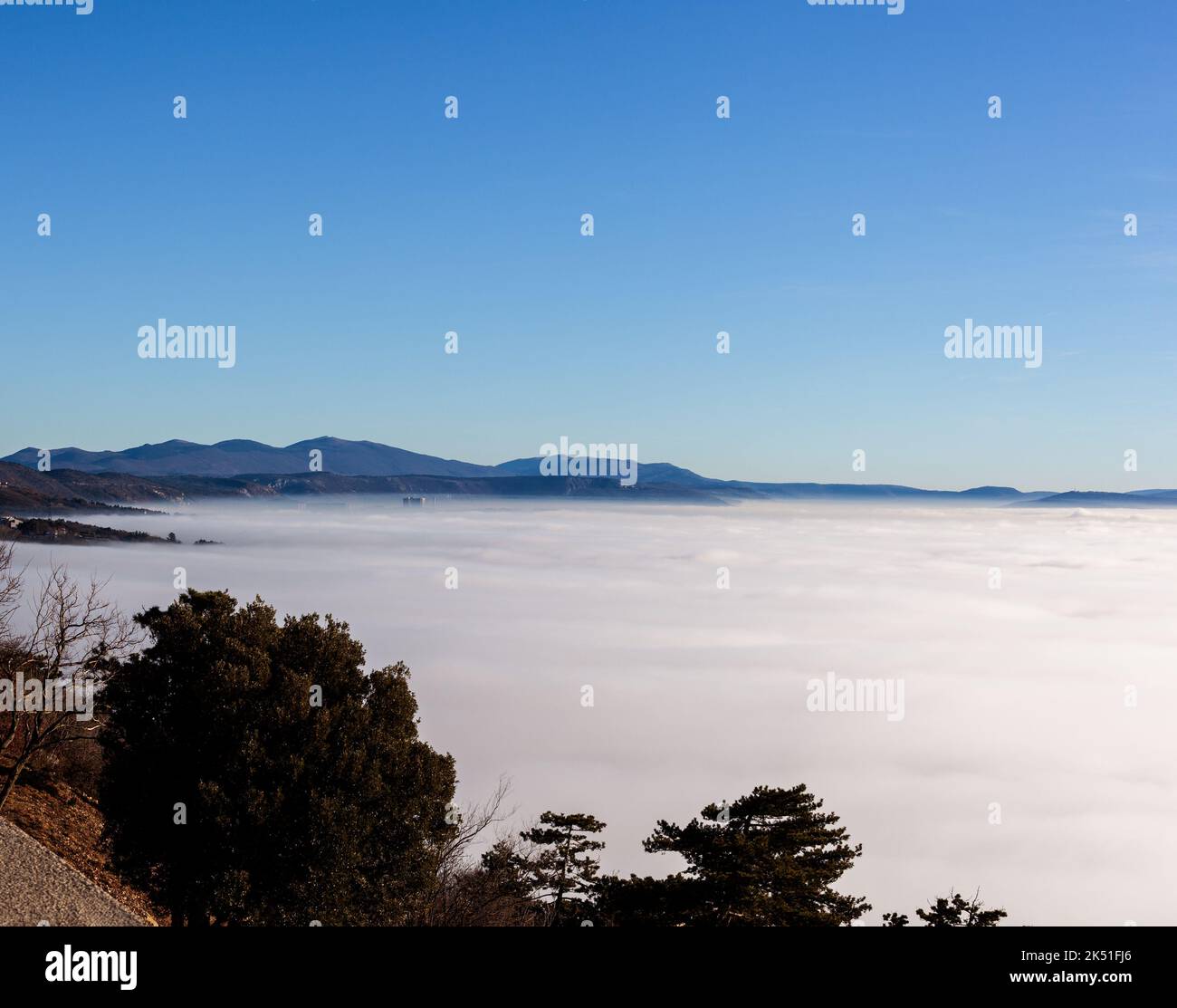 Clouds drift amid rocky cliffs in the Trieste landscape Stock Photo - Alamy