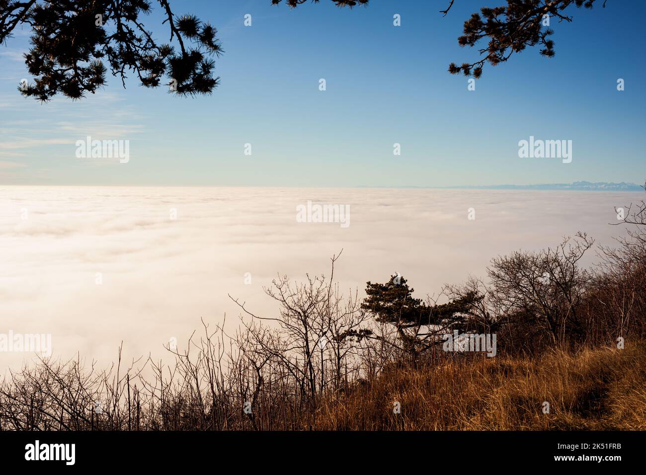 Clouds drift amid rocky cliffs in the Trieste landscape Stock Photo - Alamy