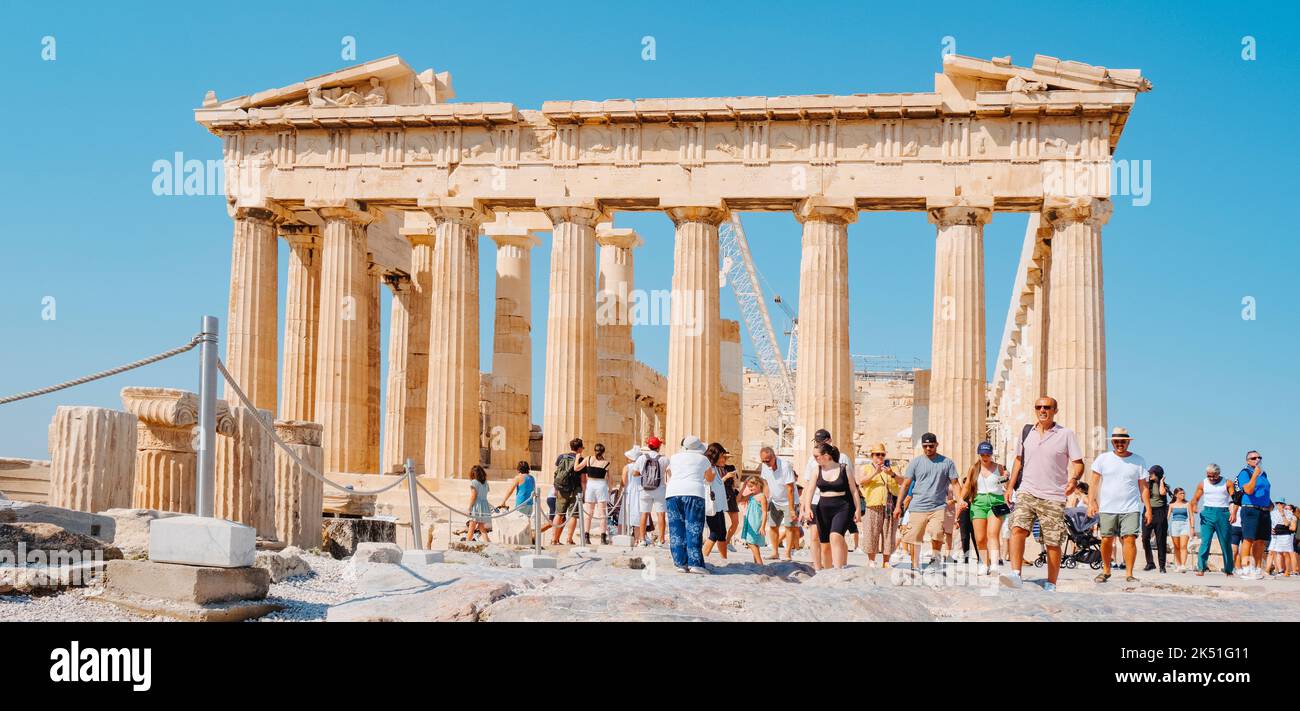 Athens, Greece - August 30, 2022: A group of visitors observe the remains of the Parthenon, in ...