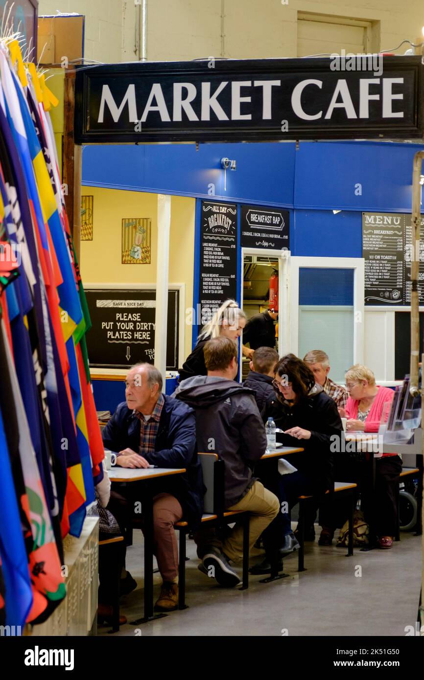 High street shop fronts in Bath. The Market cafe in the Guildhall ...