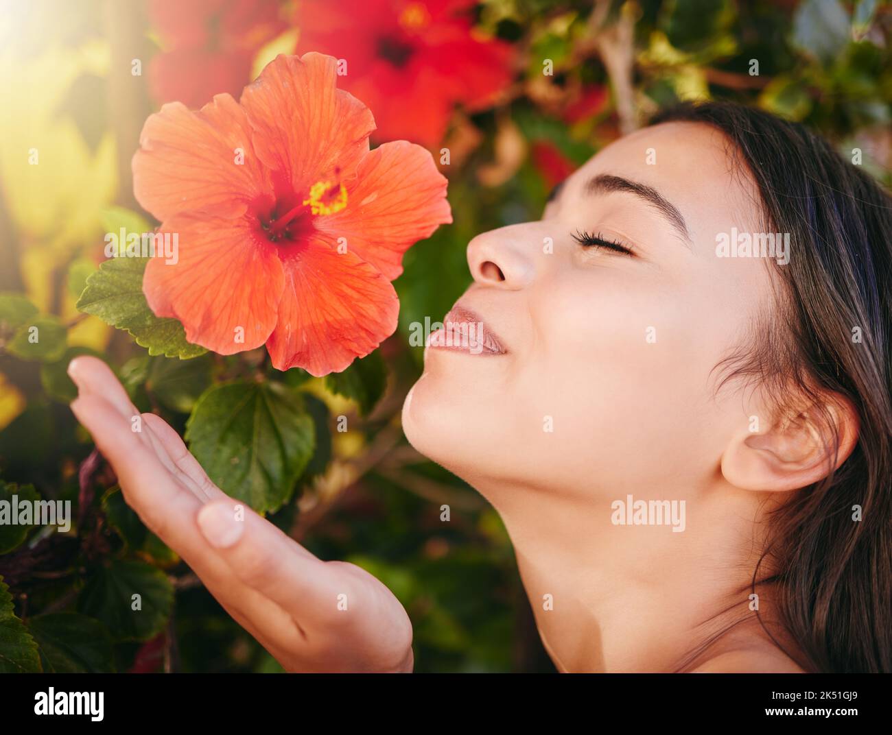 Beauty woman, smelling flowers and spring season in a garden or nature ...