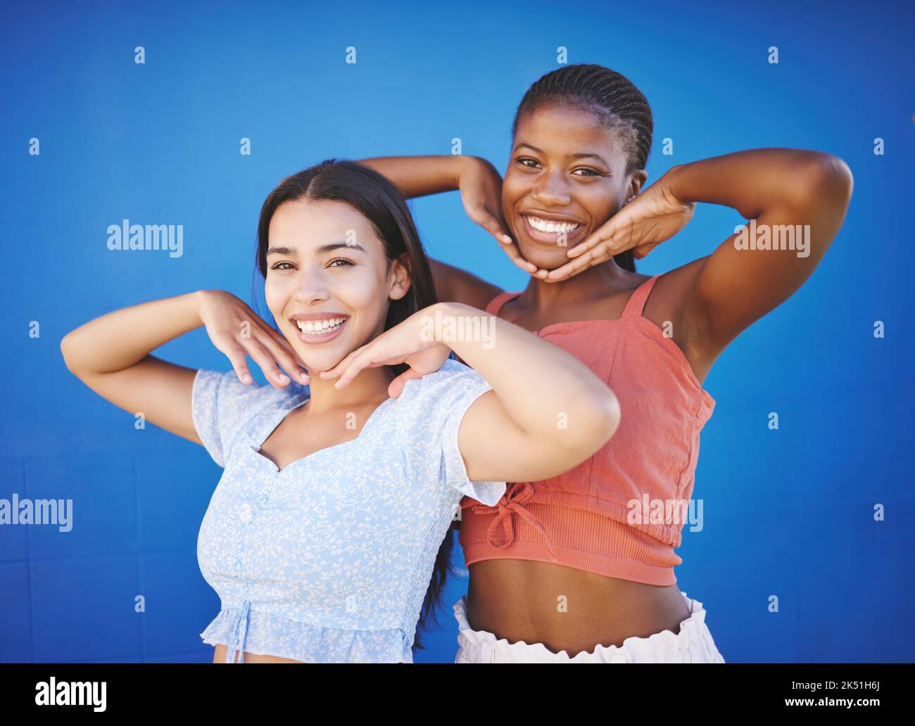 Cute friends happy in studio, women model fashion together on blue ...