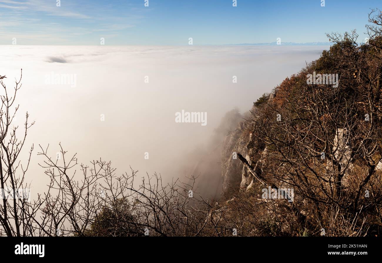 Clouds drift amid rocky cliffs in the Trieste landscape Stock Photo - Alamy