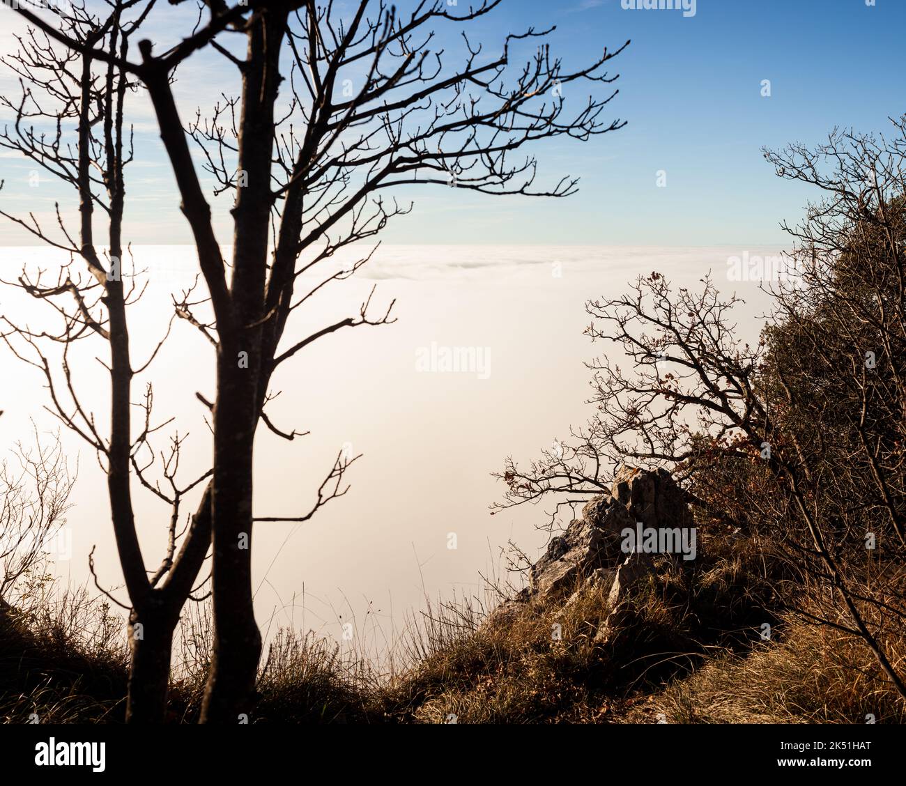Clouds drift amid rocky cliffs in the Trieste landscape Stock Photo - Alamy