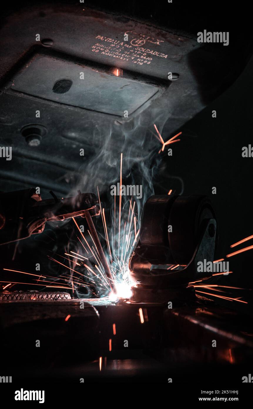 Tech welding some wheels on a steel profile to serve as a carriage for ...