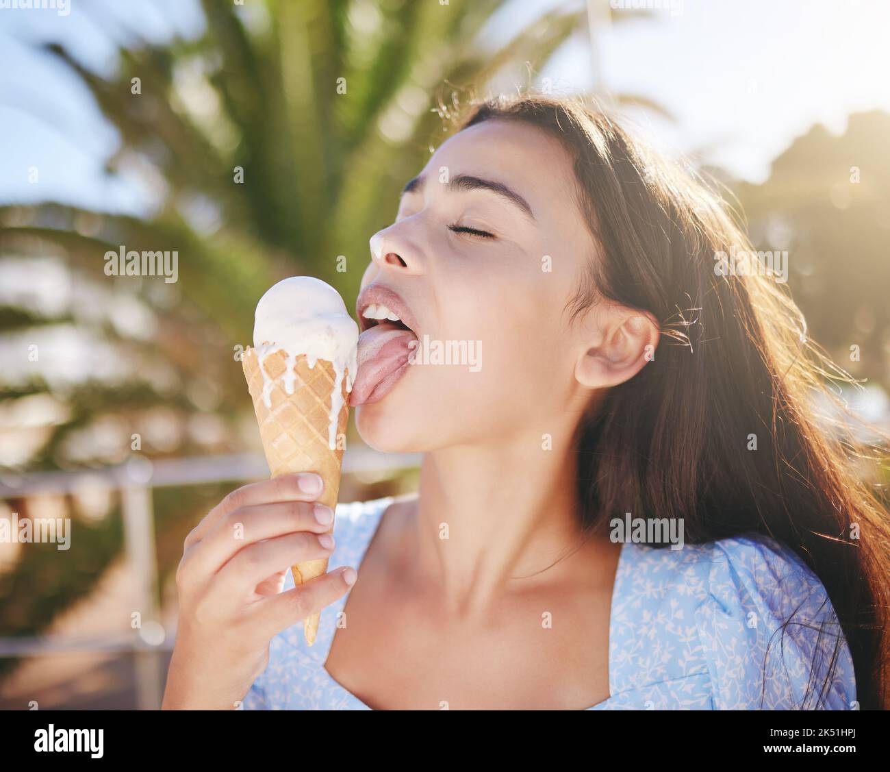 Ice cream cone eating, woman and summer dessert to enjoy on vacation, holiday and relaxing ...