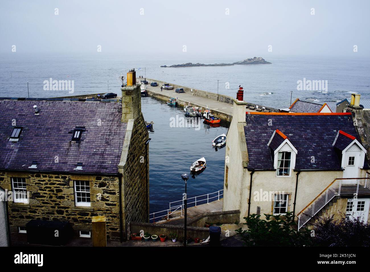 A high-angle shot of the buildings of Gardenstown, Scotland and a ...