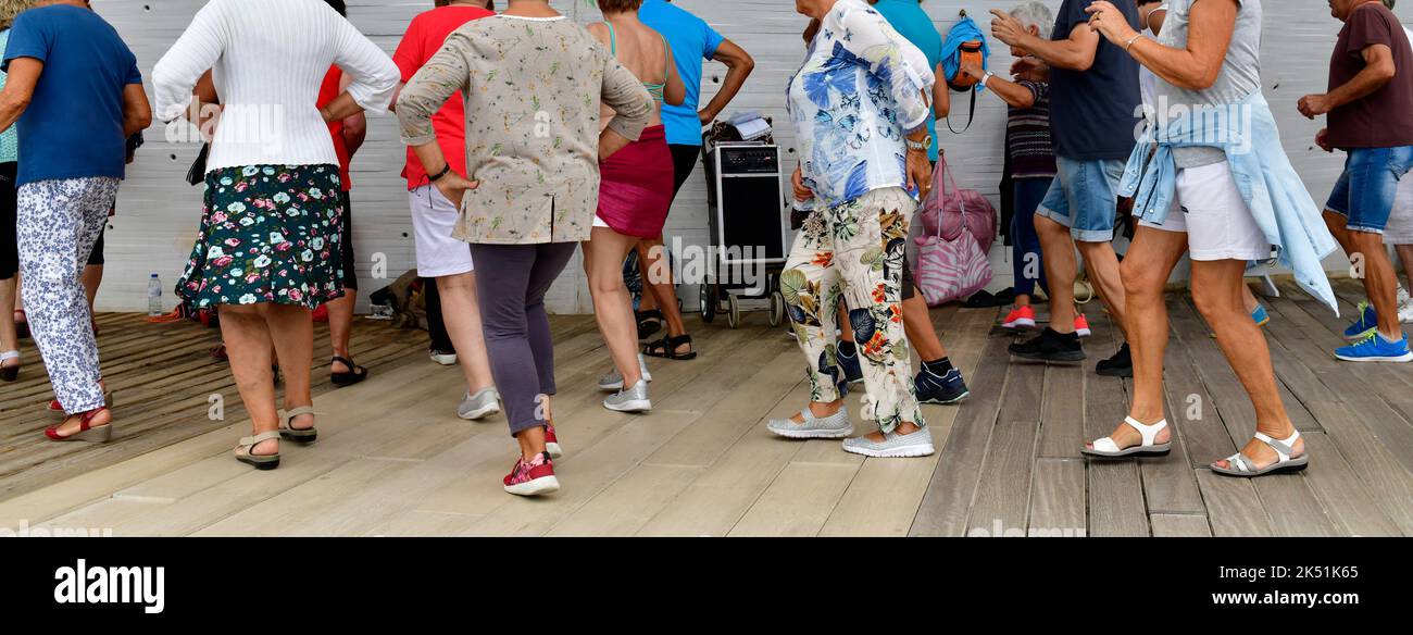 Group of senior citizens dancing in the street. Health for the elderly ...