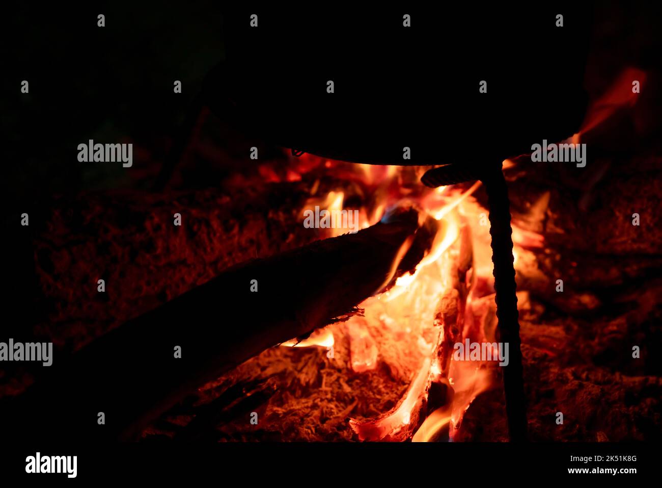 Food cooking on a bonfire at night. Firewood solid fuel for cook at ...