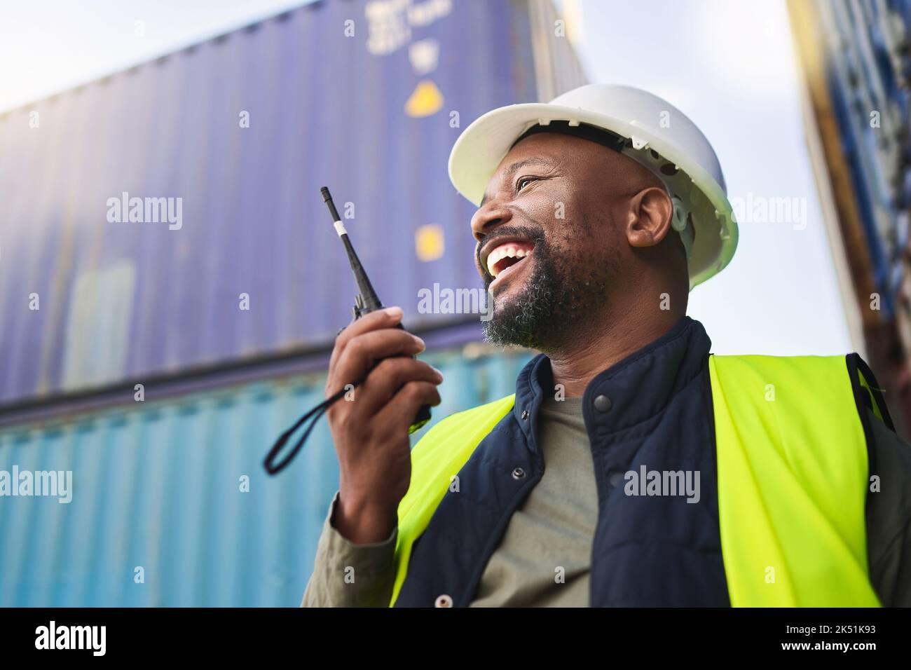 Logistics, supply chain and radio with a man delivery worker talking on ...