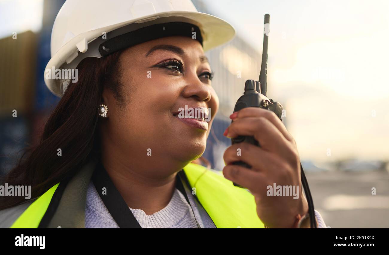 Logistics, delivery and black woman in communication via radio for ...