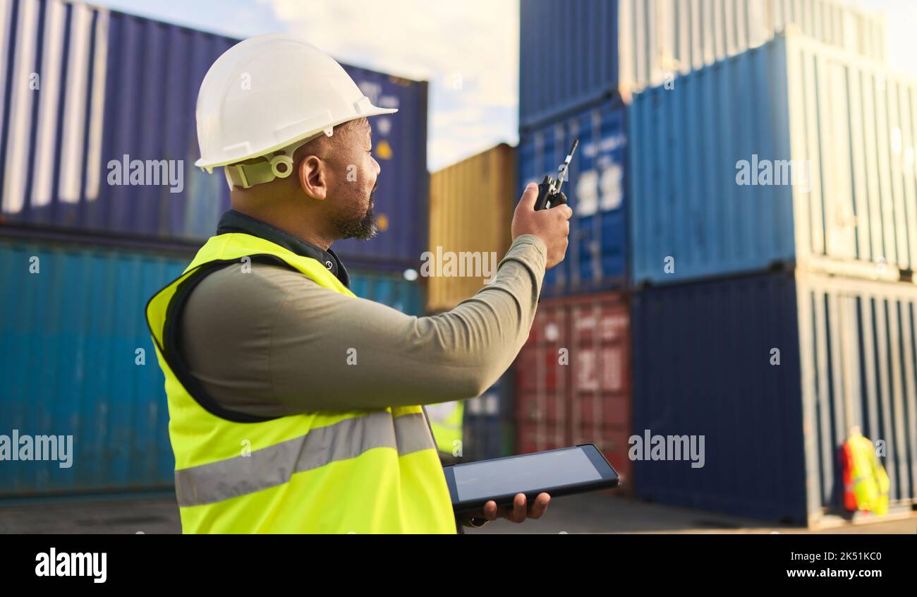 Logistics, supply chain and shipping with a man, tablet and radio to ...