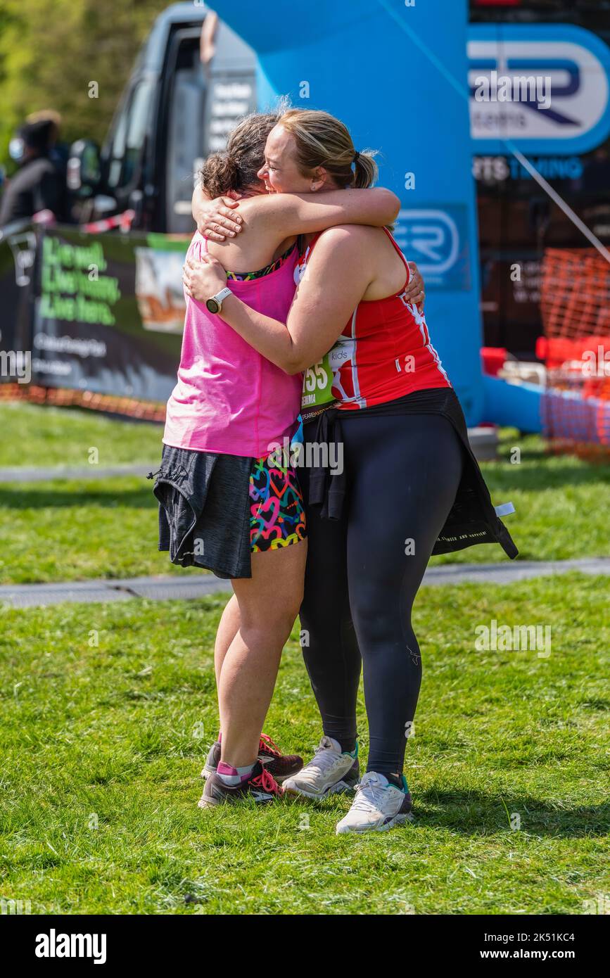 Shakespeare Marathon and half Marathon. Two women runners hugging in ...