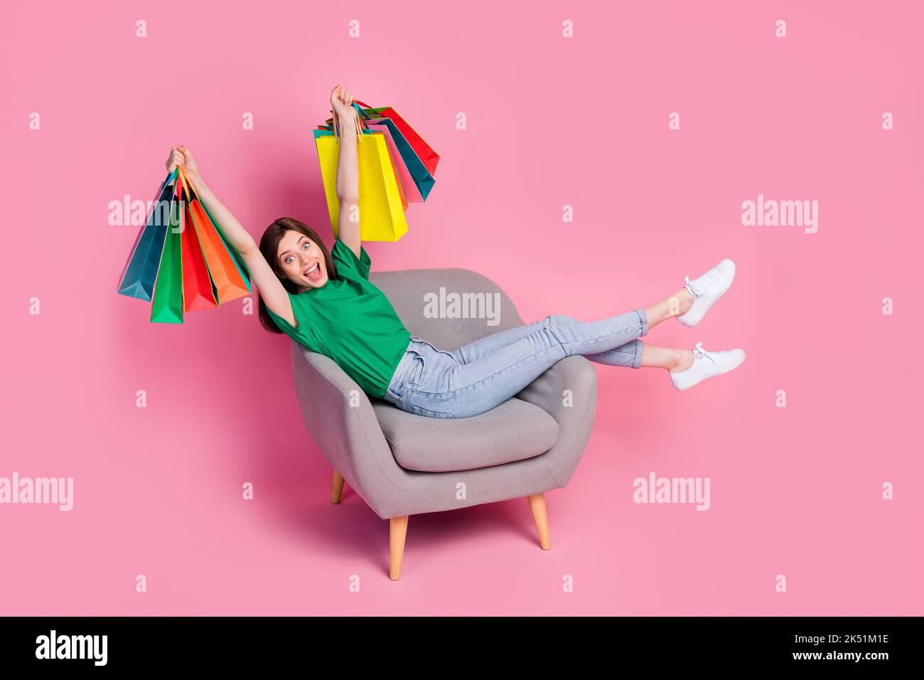 Full length photo of overjoyed positive person sit chair hands hold ...