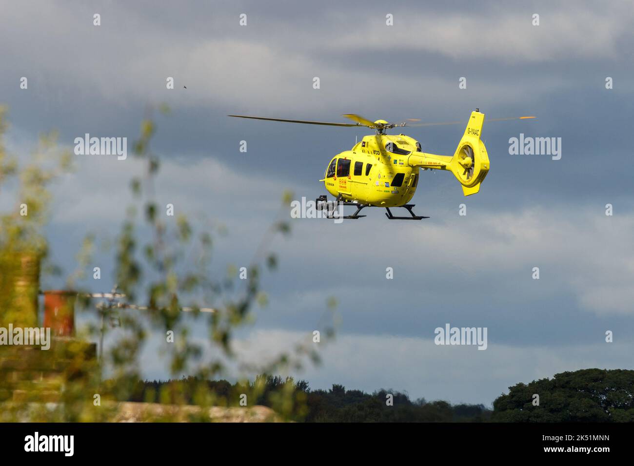 The Yorkshire air ambulance flying over Honley, West Yorkshire Stock ...