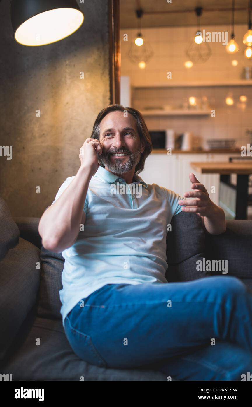 A man talking on the phone and looking excited Stock Photo - Alamy