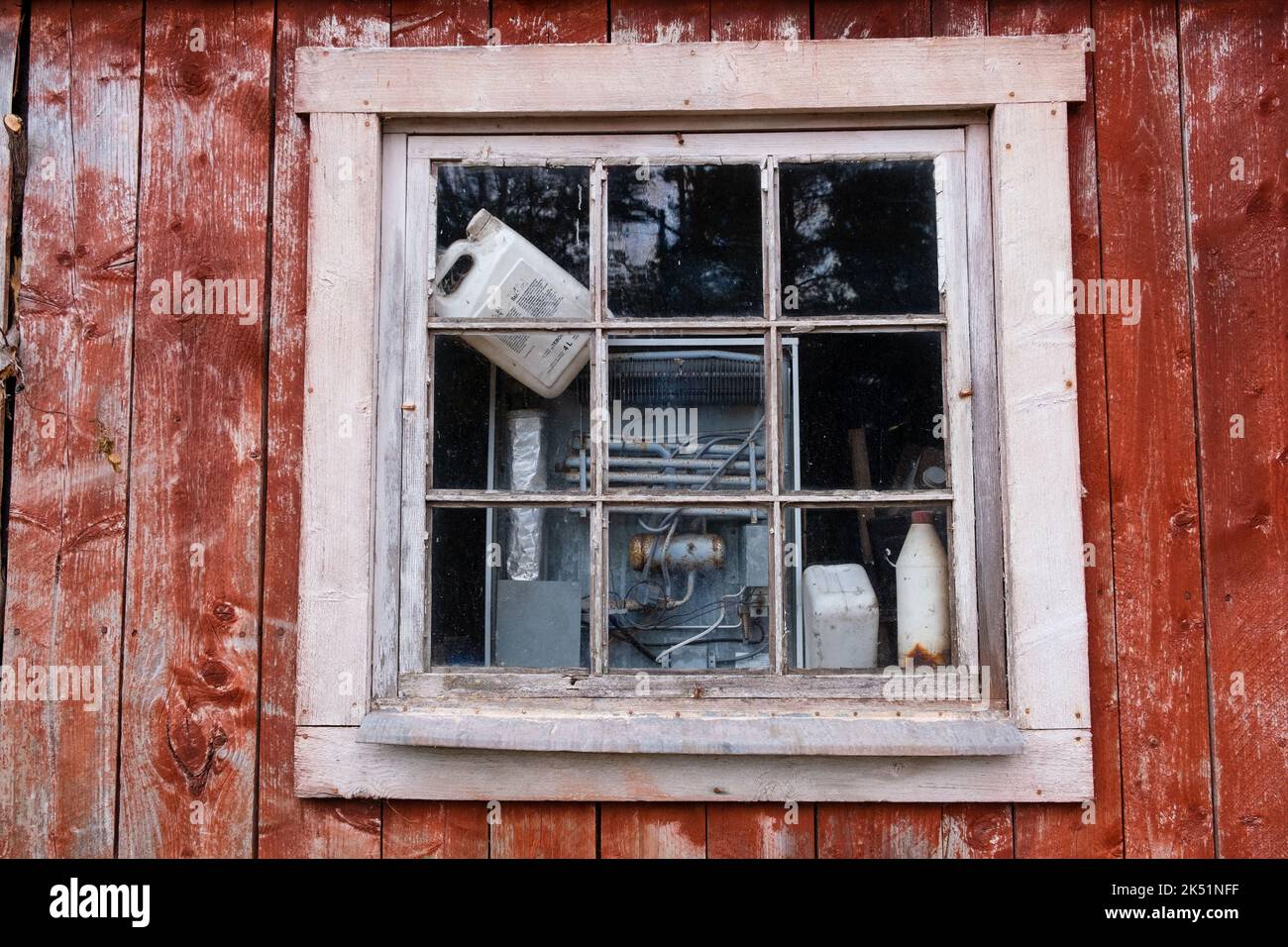 A cluttered window in a traditional red paint cabin. Åutumn in the ...
