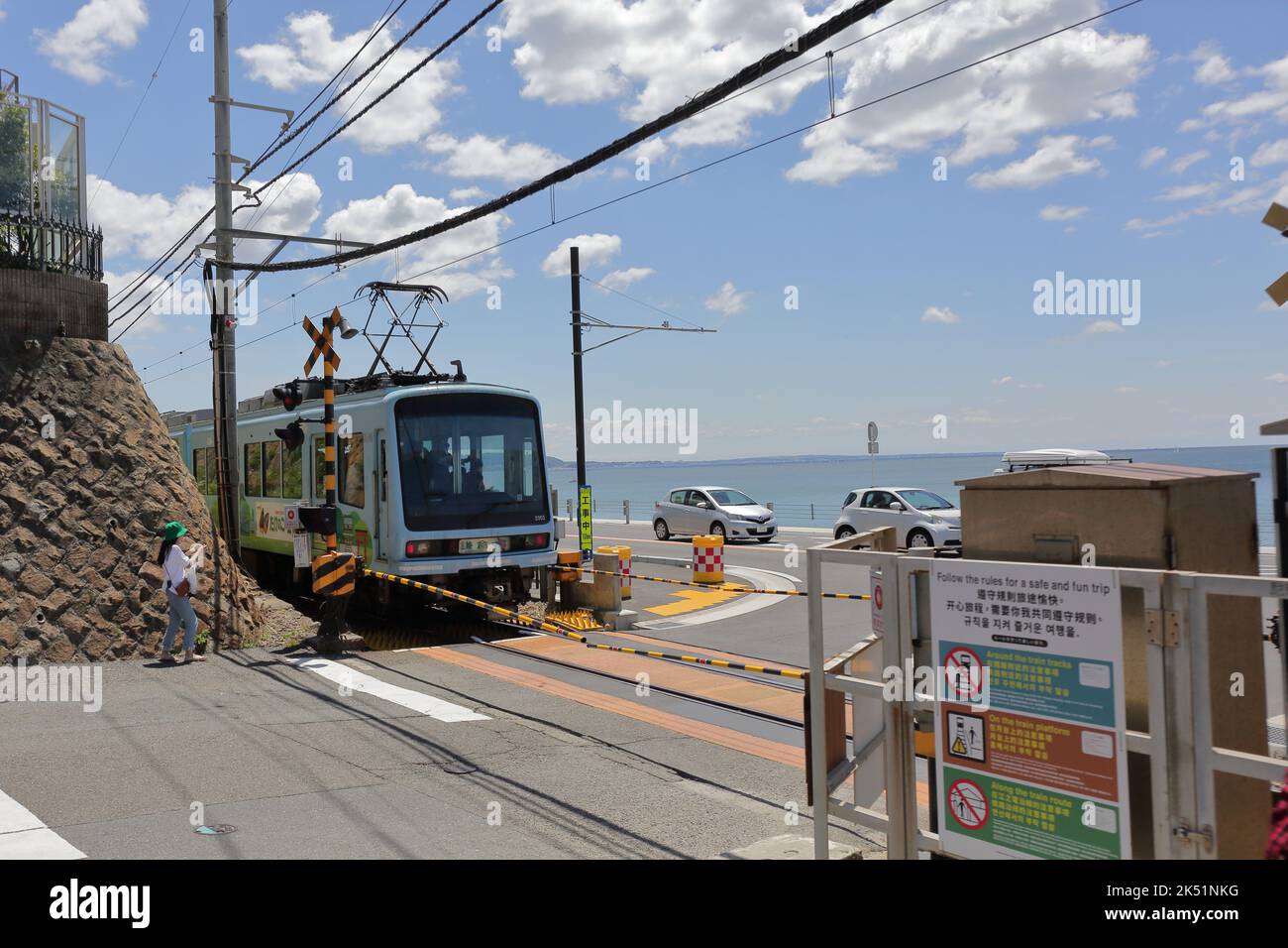 the train of Enoshima Electric Railway is passing the level crossing ...