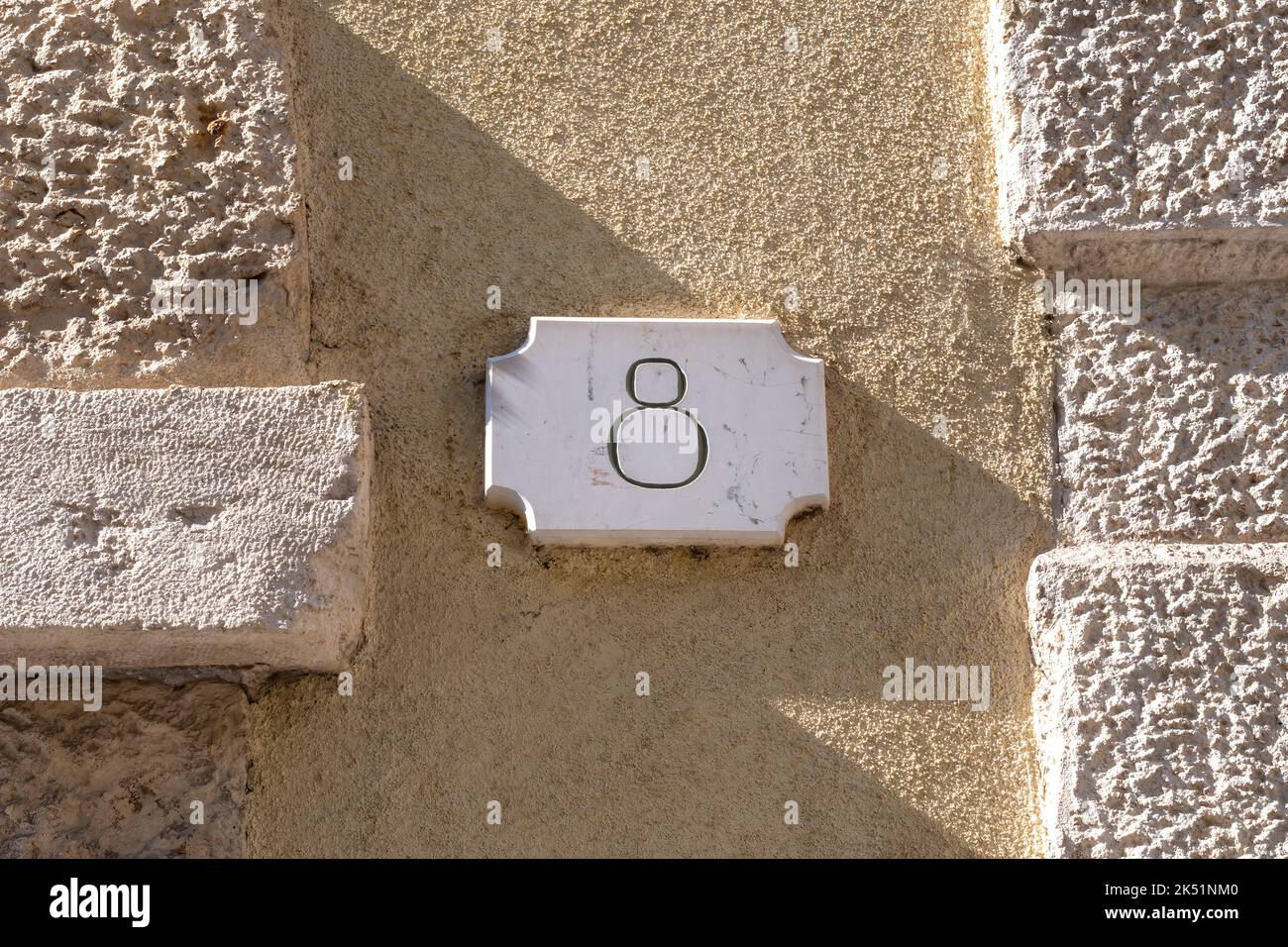 Number eight door number on plaster and brickwork Stock Photo - Alamy