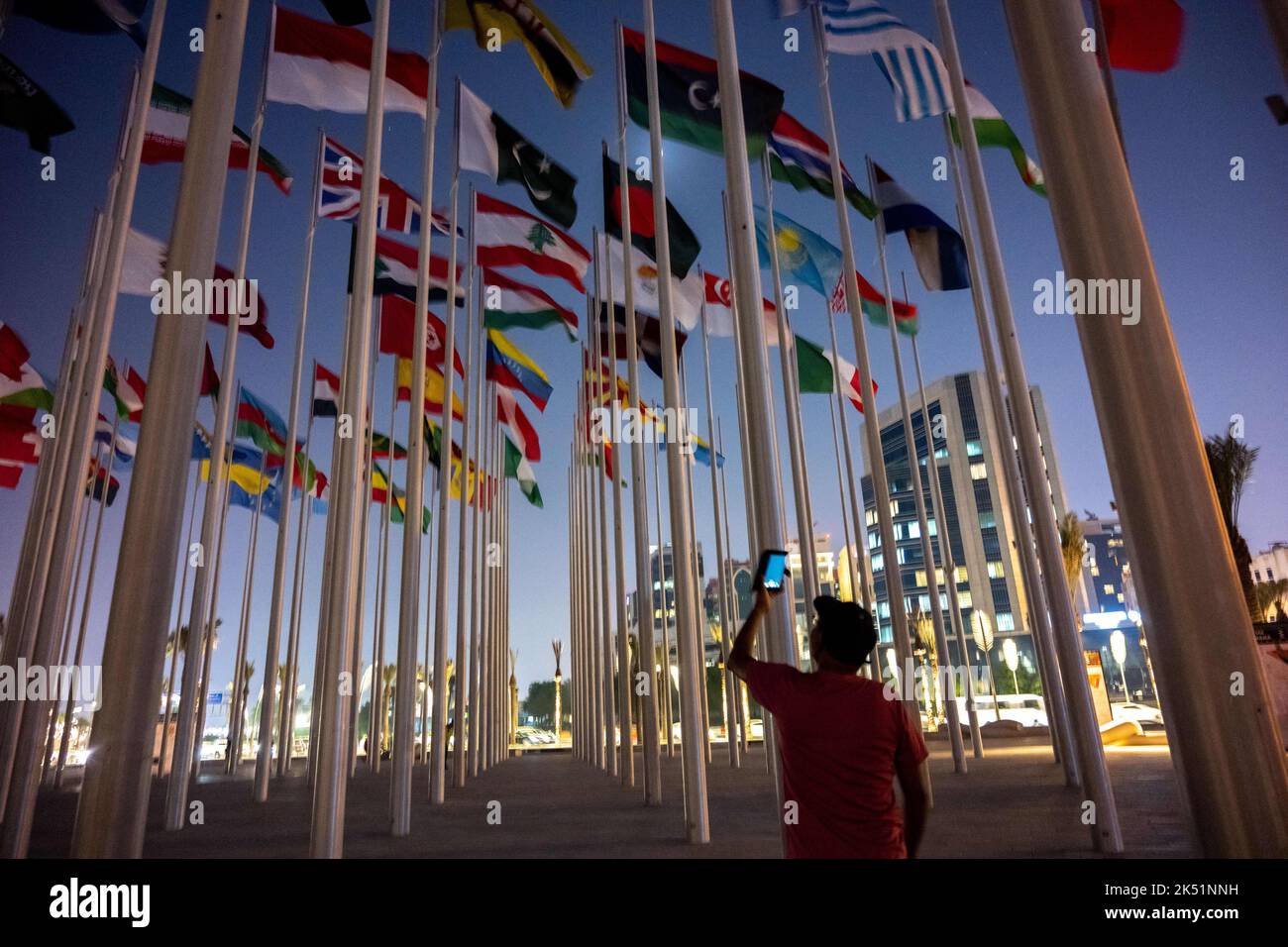 A visitor takes a photograph of 120 flags, from all countries ...