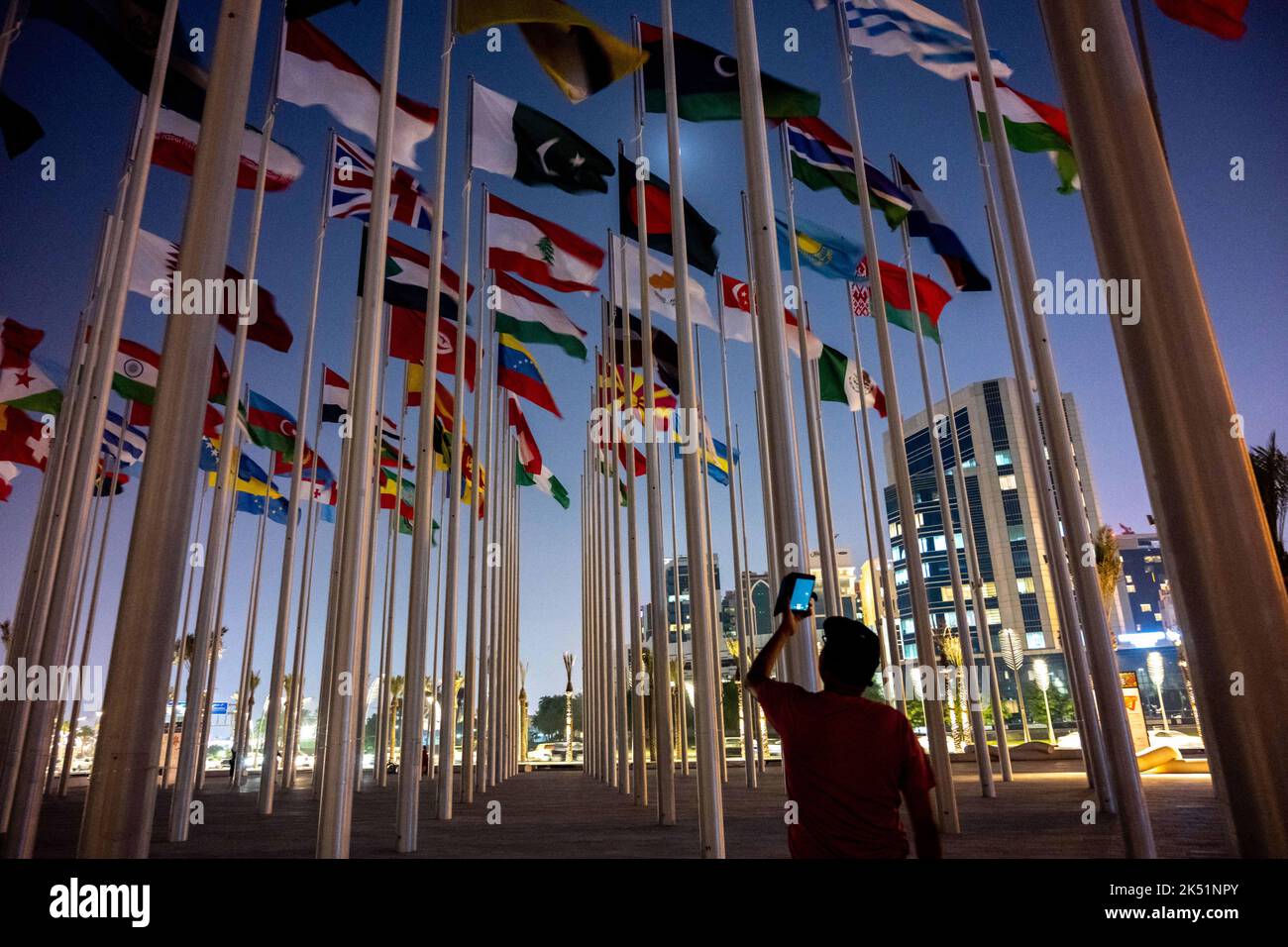 A visitor takes a photograph of 120 flags, from all countries ...