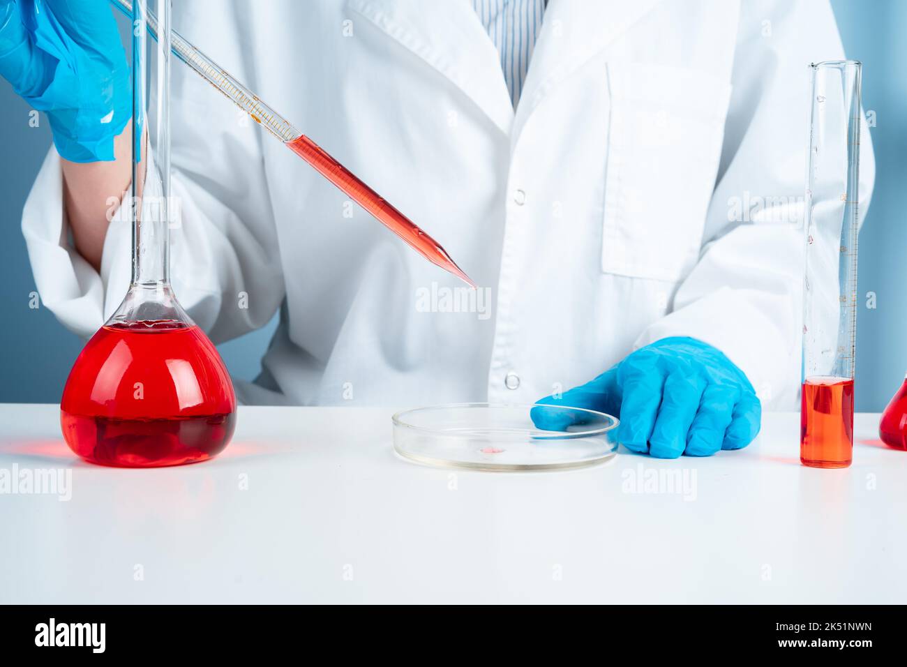 Young scientist with test tube making research in clinical laboratory ...