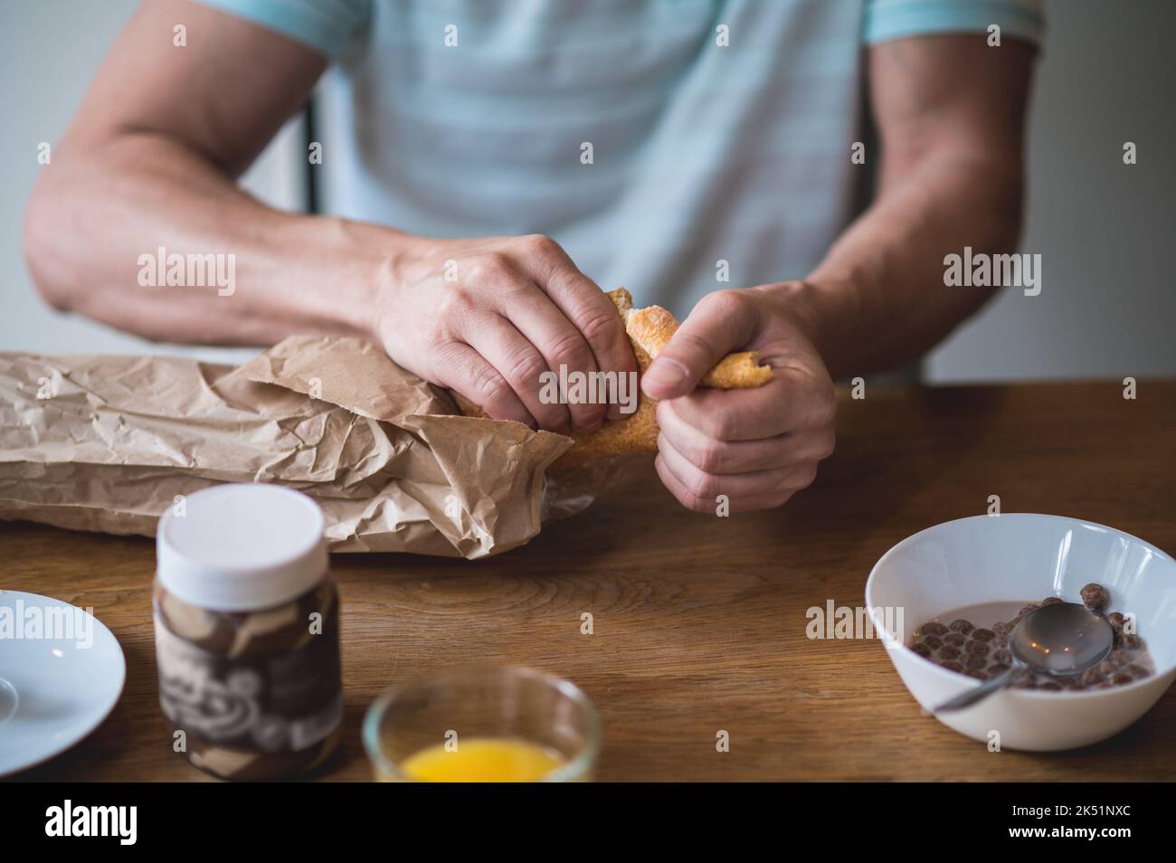 Close up picture of man breaking bread for sandwiches Stock Photo - Alamy