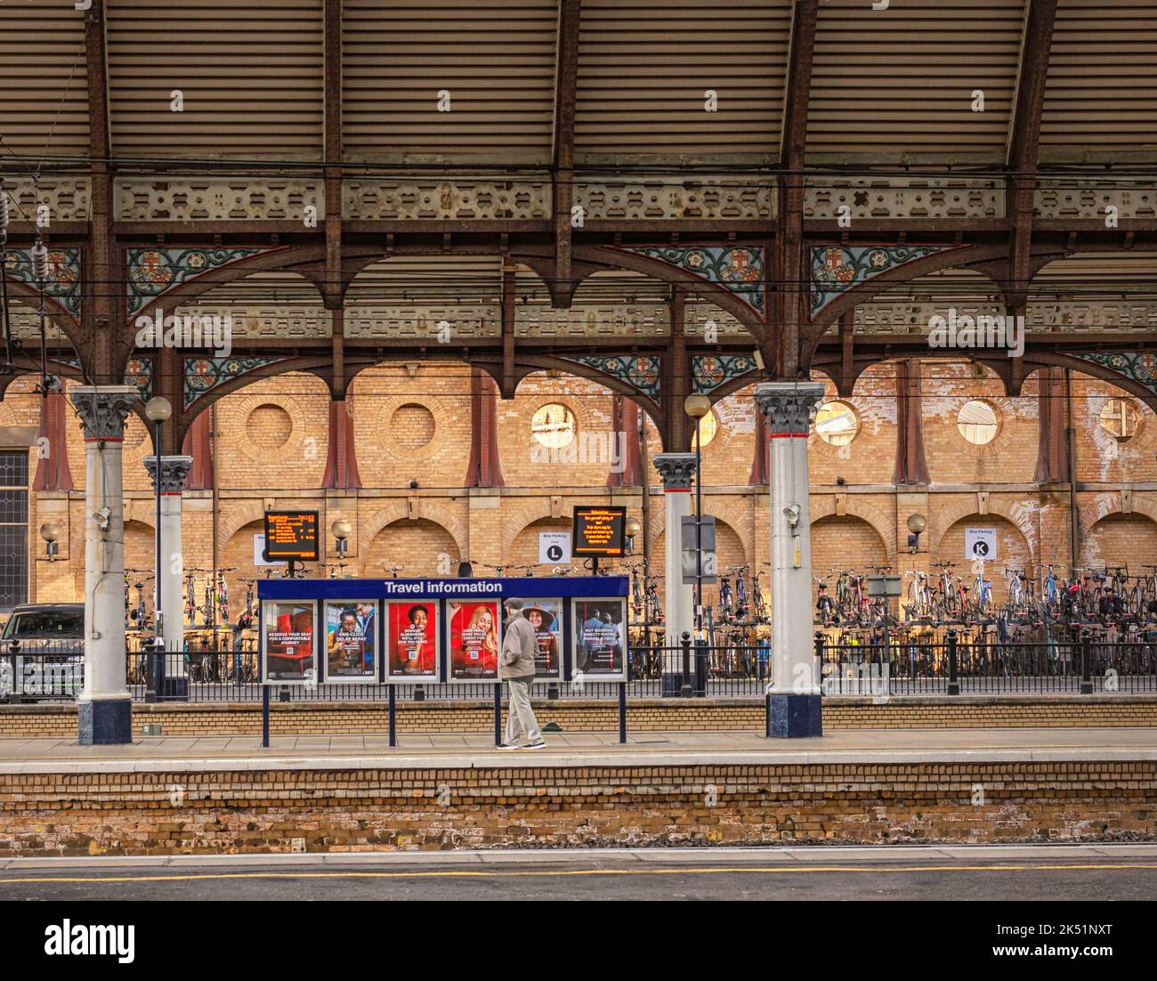 A man looks at at an advertisement on a railway station notice board as ...