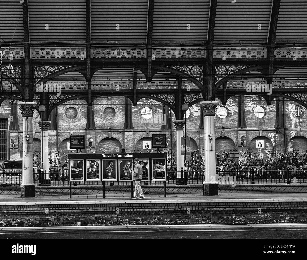 A man looks at at an advertisement on a railway station notice board as ...