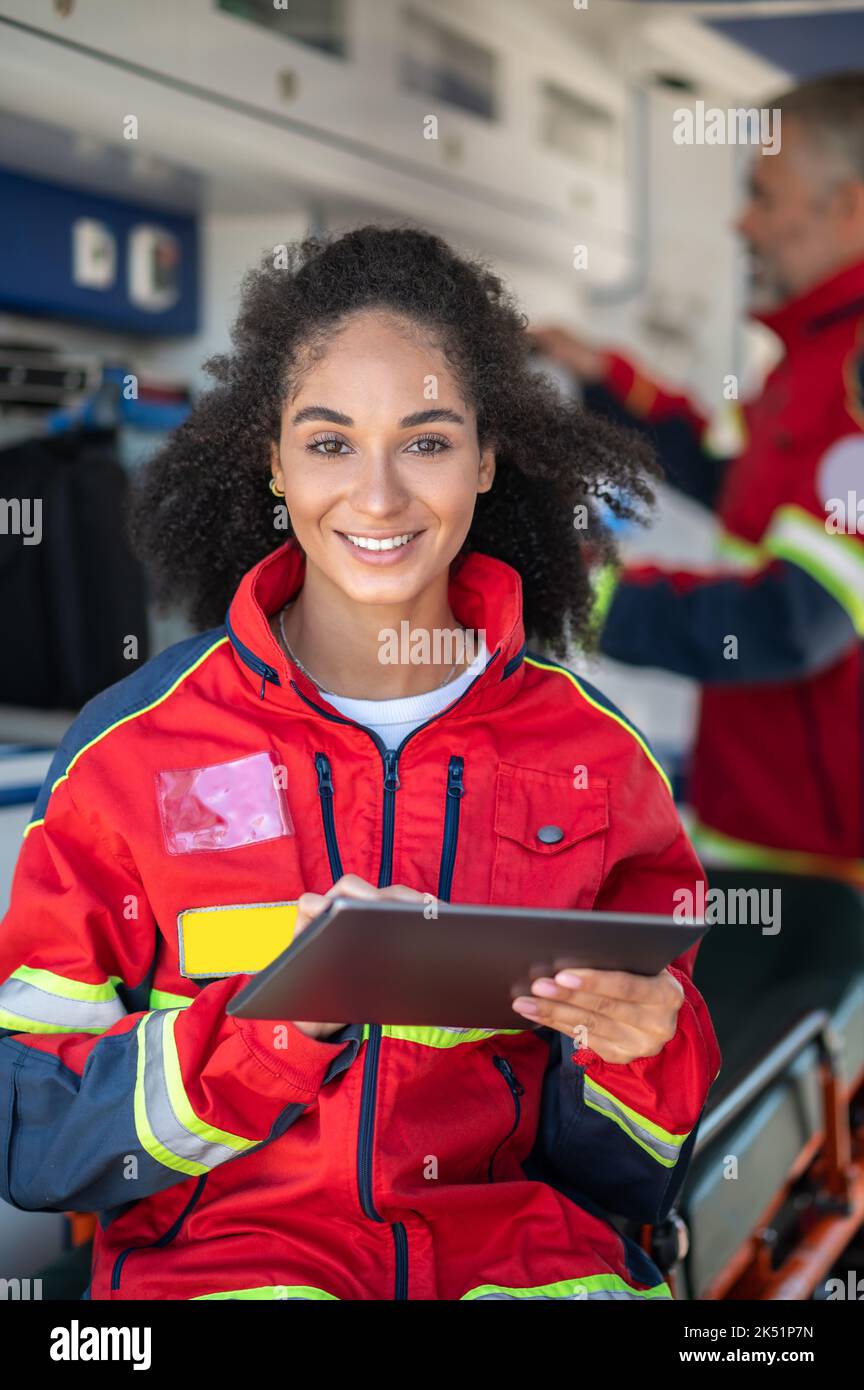 Joyous female doctor seated in the medical emergency vehicle Stock ...
