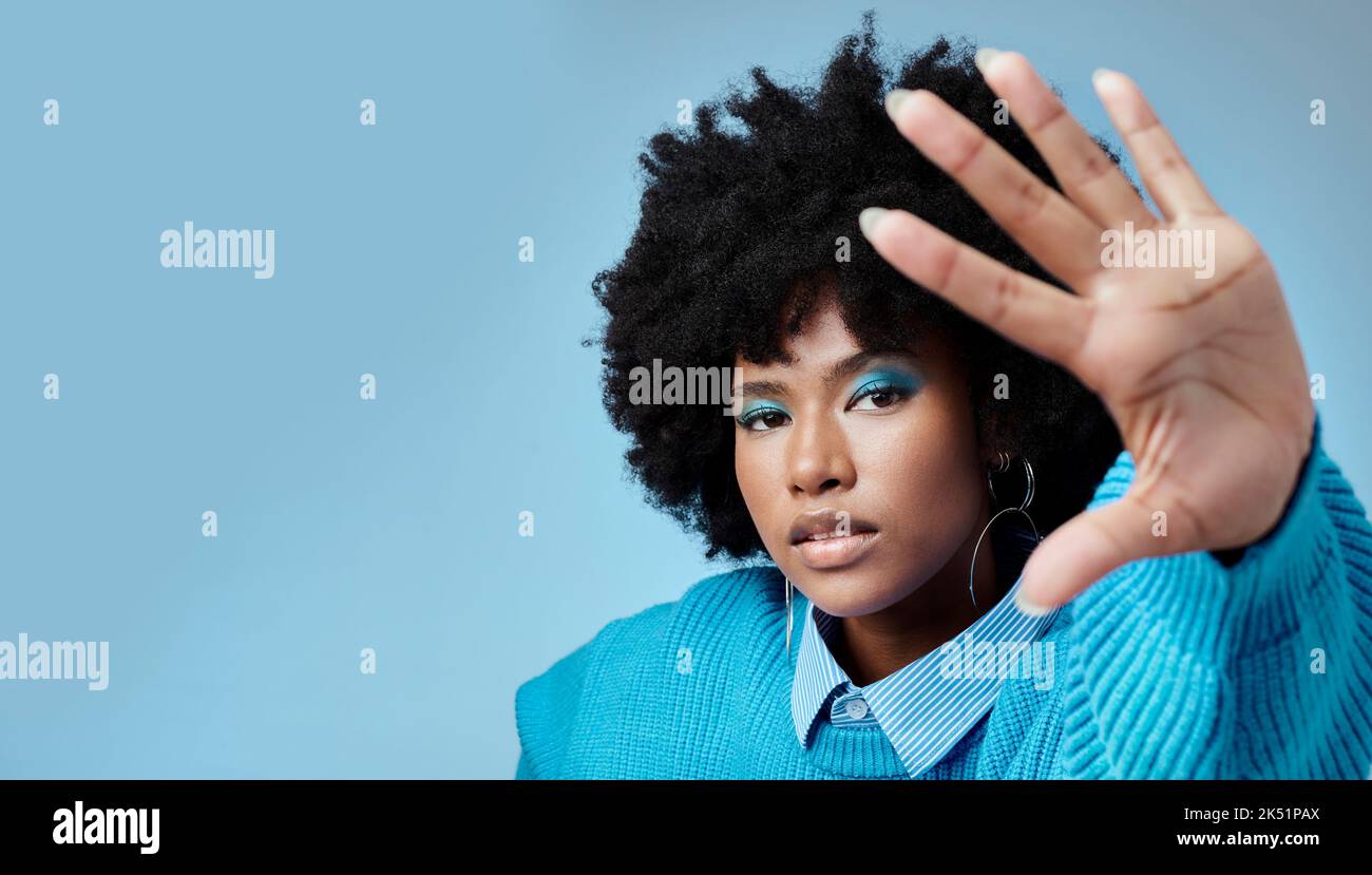 Black woman, hand and mockup with blue makeup against studio background ...