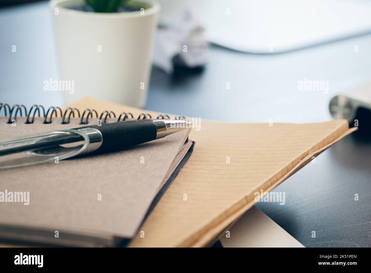 Pen and notebook up close on an office desk Stock Photo - Alamy