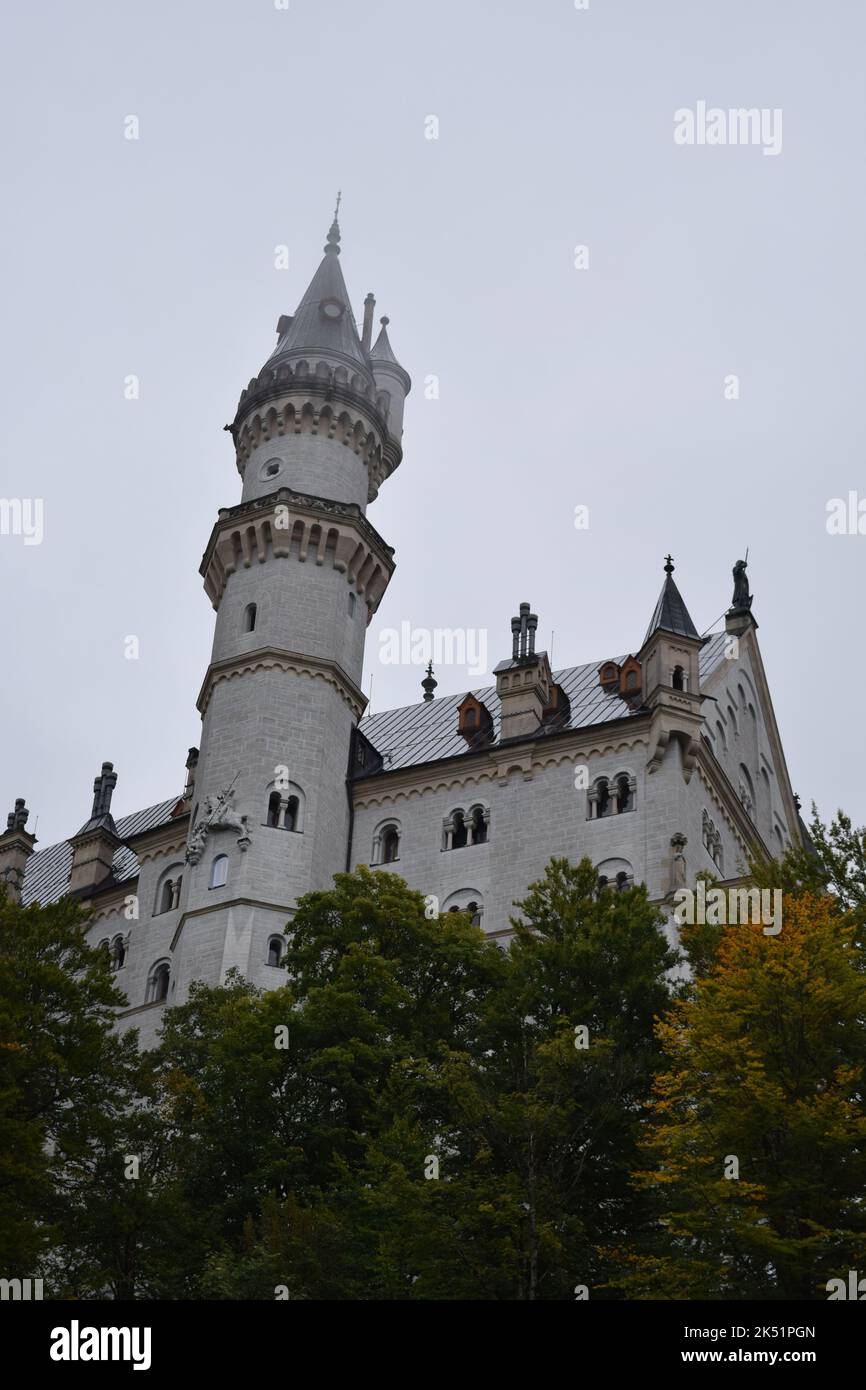 A low angle shot of a white tall castle surrounded by trees Stock Photo ...