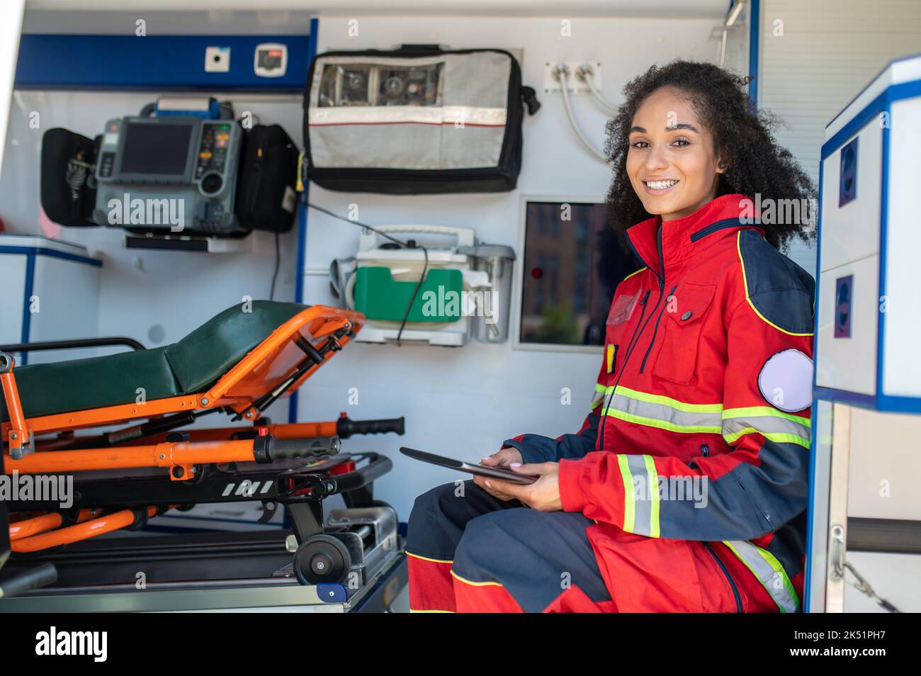 Healthcare worker posing for the camera in the ambulance car Stock ...